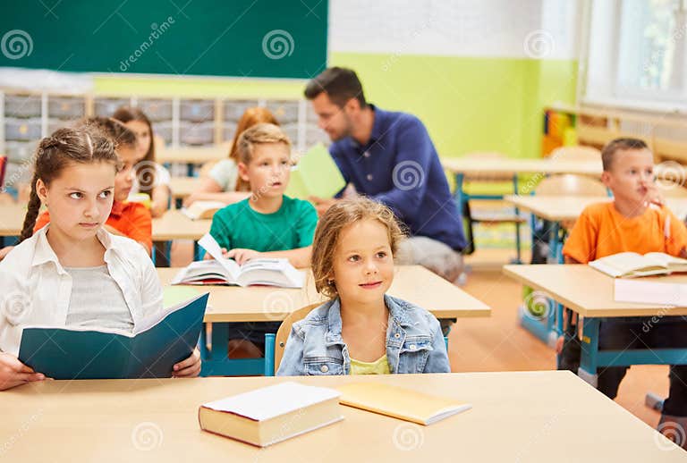 Group of Children Learning with Teacher in Elementary School Class ...