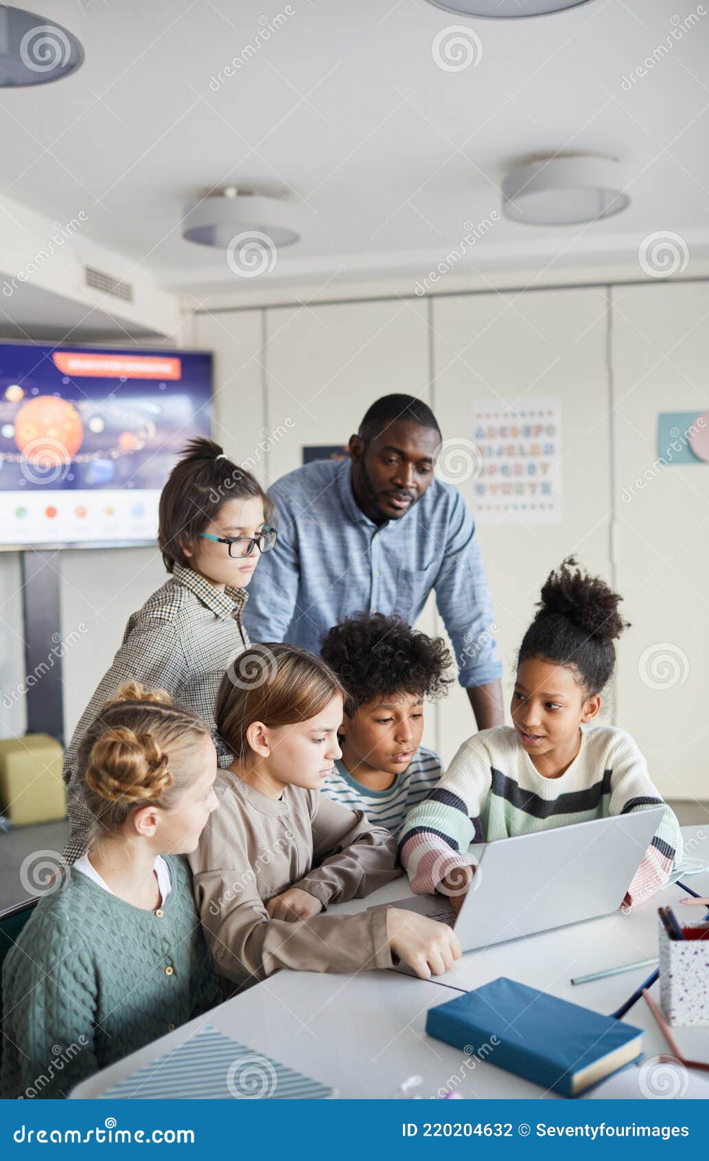 Group of Children Looking at Computer Screen in School Stock Photo ...