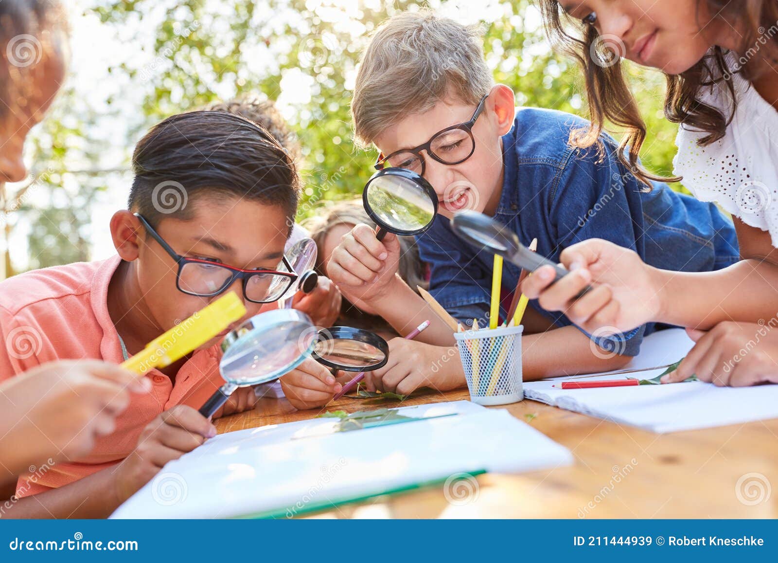 Group of Children with Magnifying Glass Curiously Look at a Leaf Stock ...