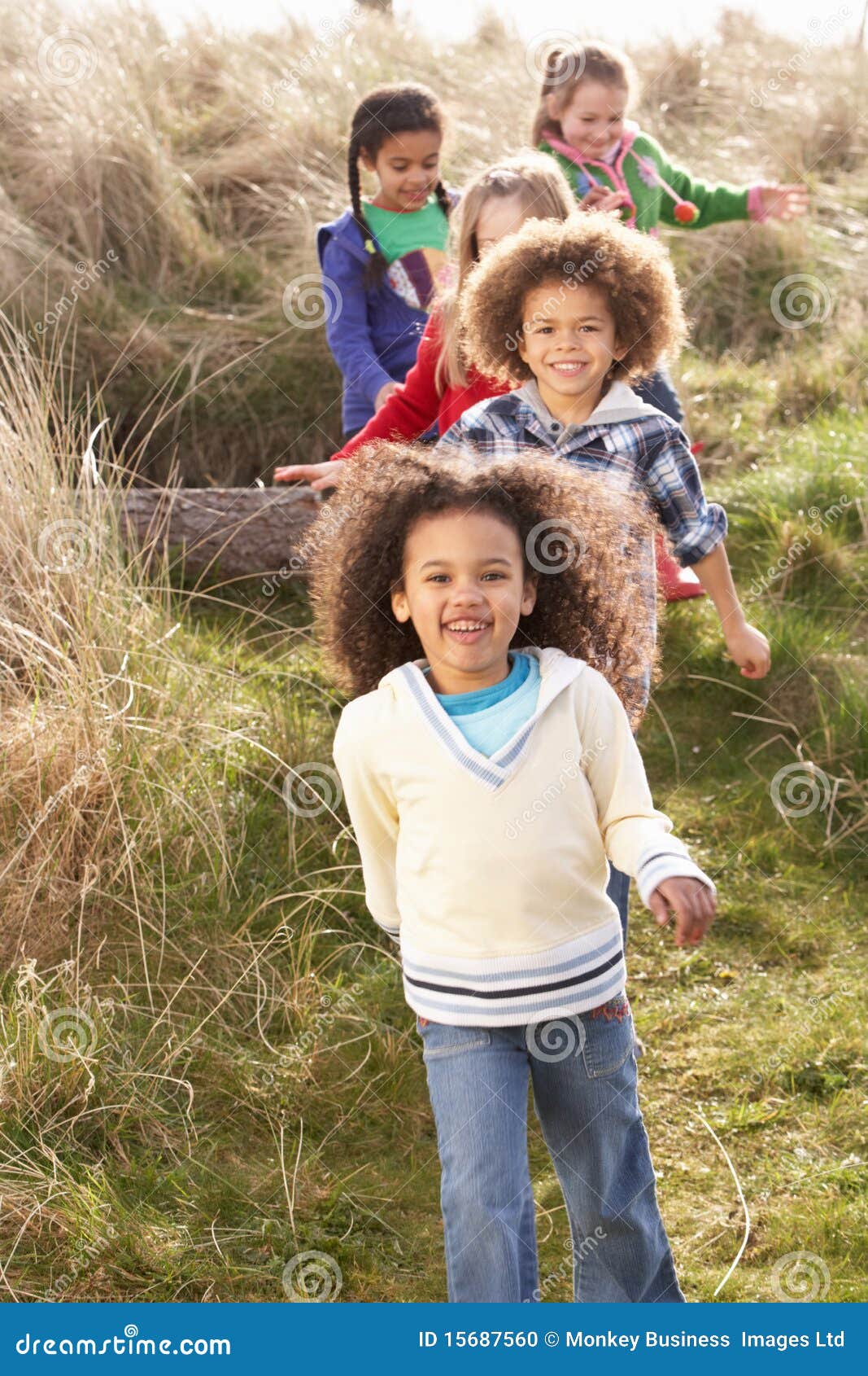 Group of Children Playing in Field Together Stock Photo - Image of ...