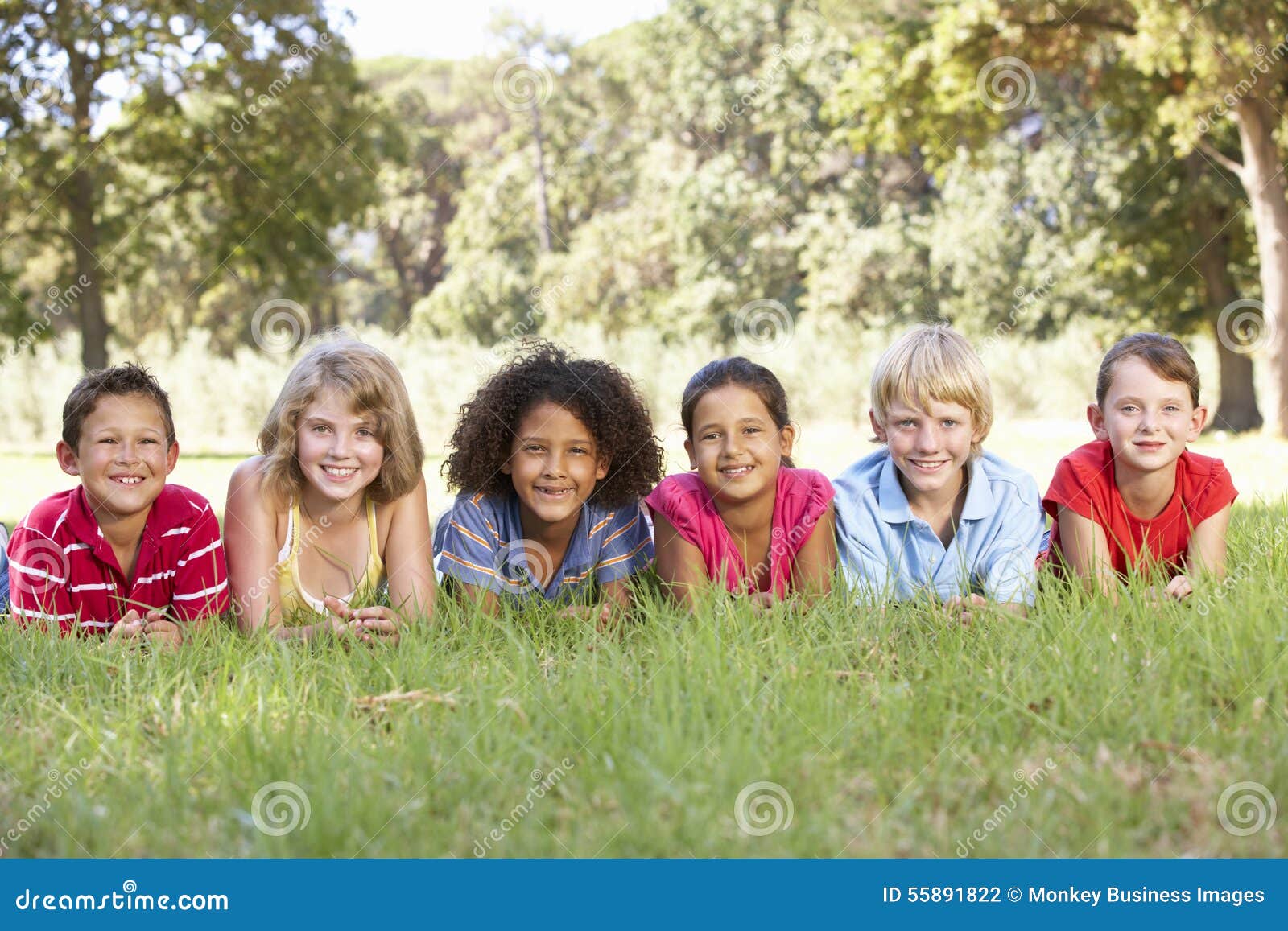 Group of Children Relaxing in Countryside Stock Photo - Image of kids ...