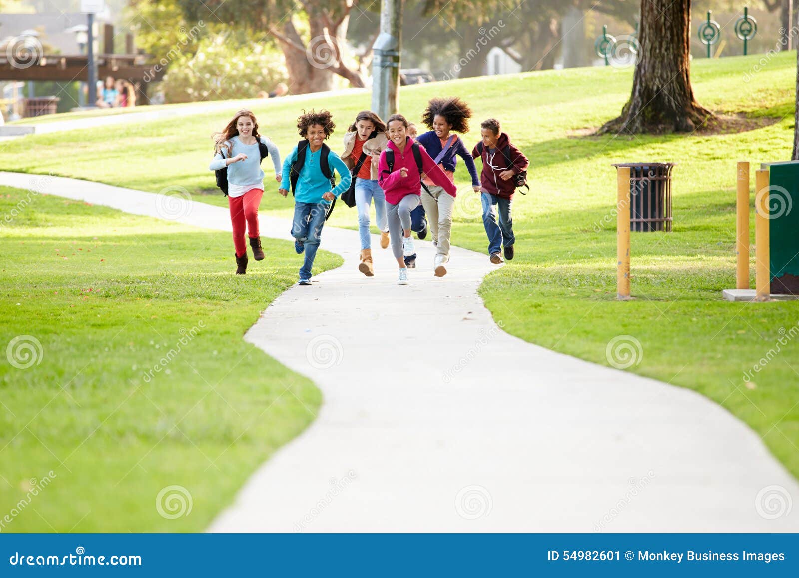 Group of Children Running Along Path Towards Camera in Park Stock Image ...
