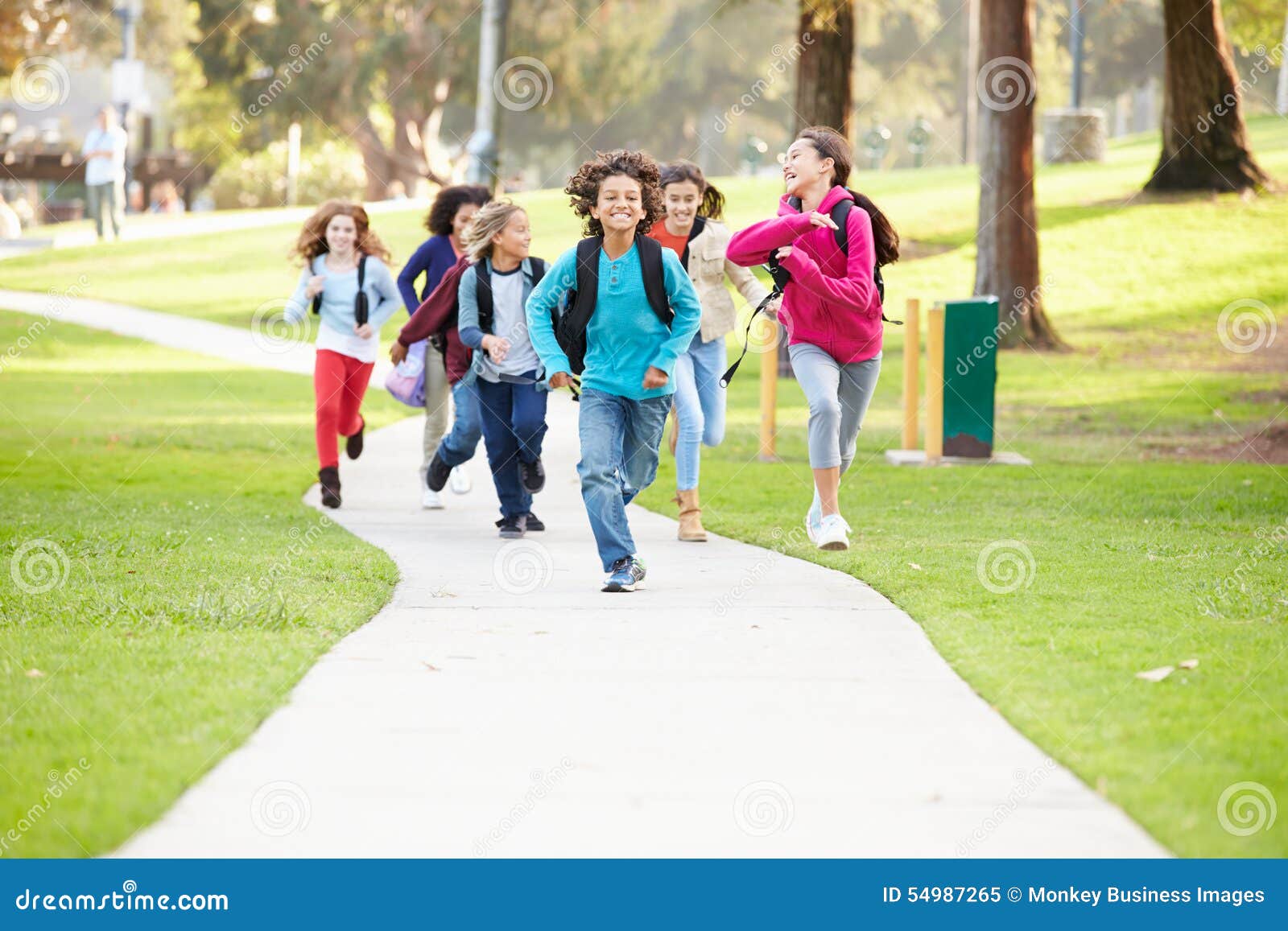 Group of Children Running Along Path Towards Camera in Park Stock Image ...
