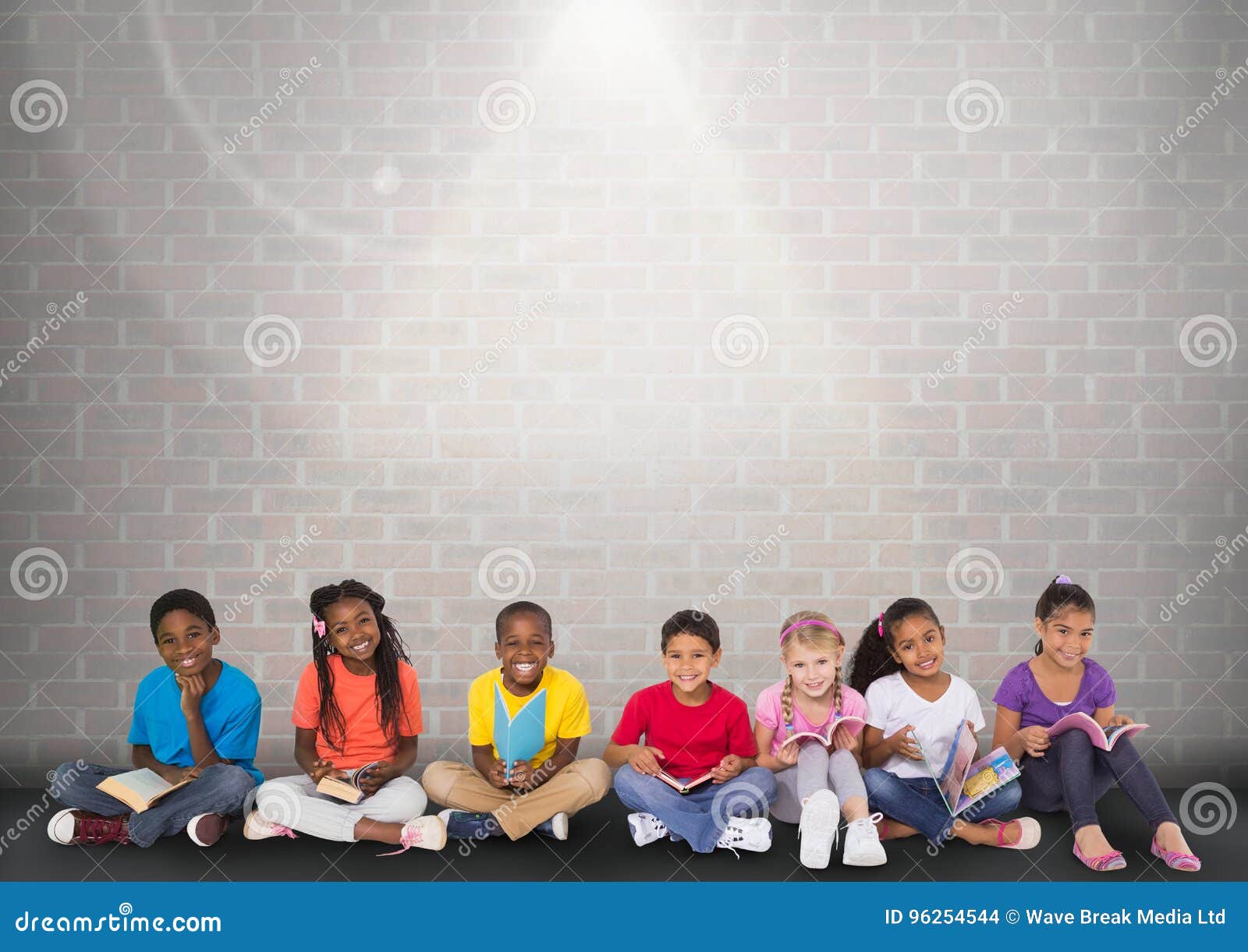 Group of Children Sitting in Front of Brick Grey Background Stock Photo ...