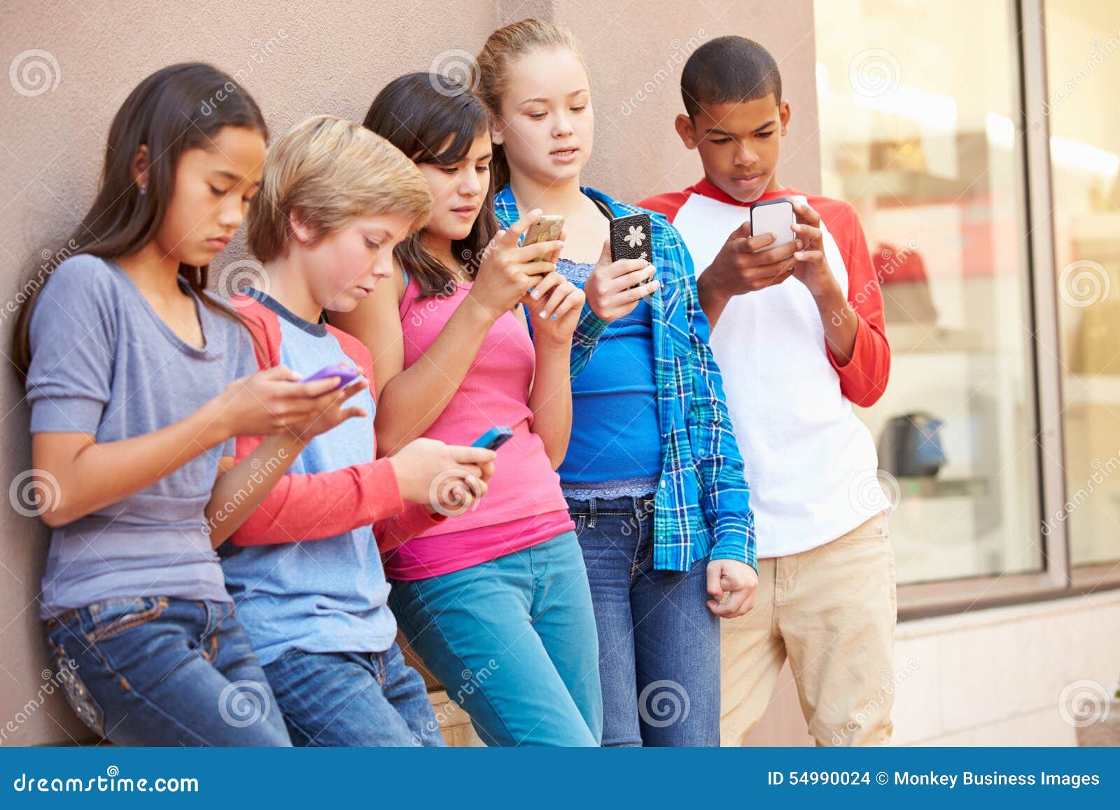 Group of Children Sitting in Mall Using Mobile Phones Stock Photo ...