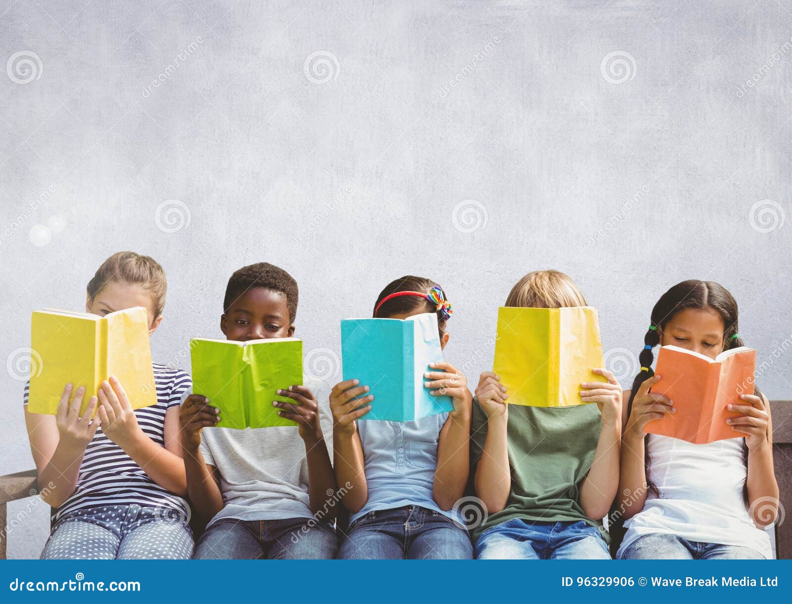 Group of Children Sitting and Reading in Front of Grey Background Stock ...