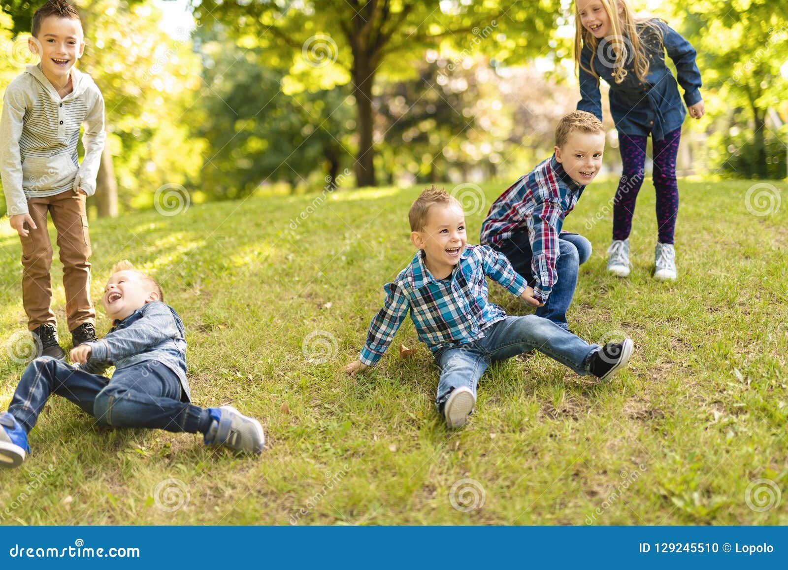 A Group of Children in Spring Field Having Fun Stock Photo - Image of ...