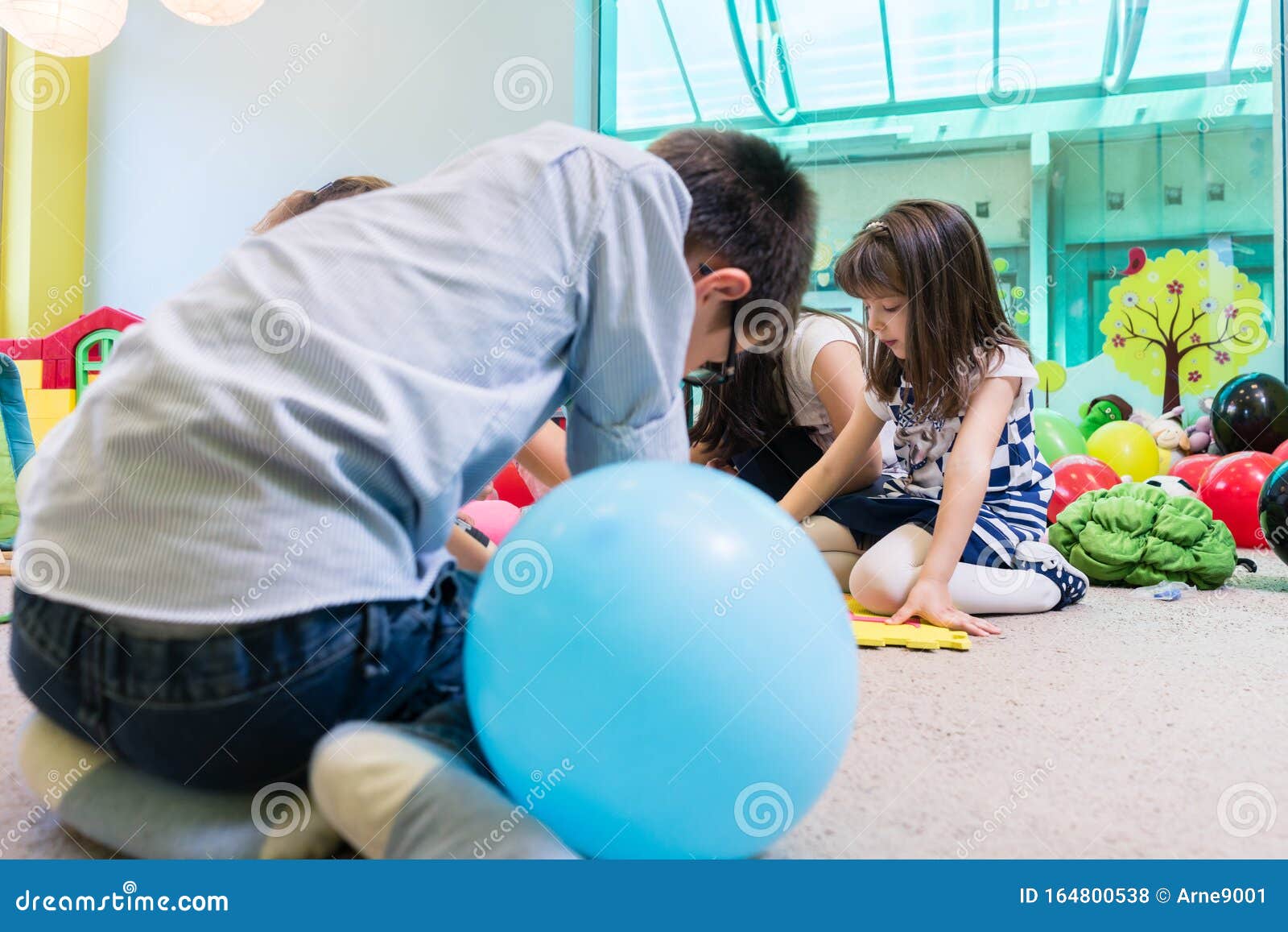 Group of Children Surrounding Their Teacher during Educational Activity ...
