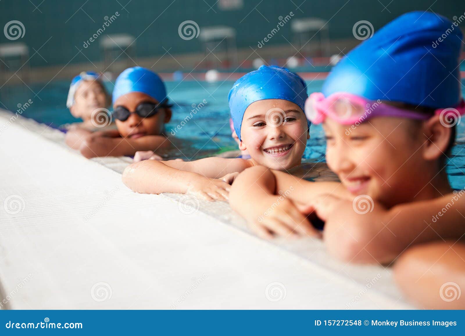 Group of Children in Water at Edge of Pool Waiting for Swimming Lesson ...