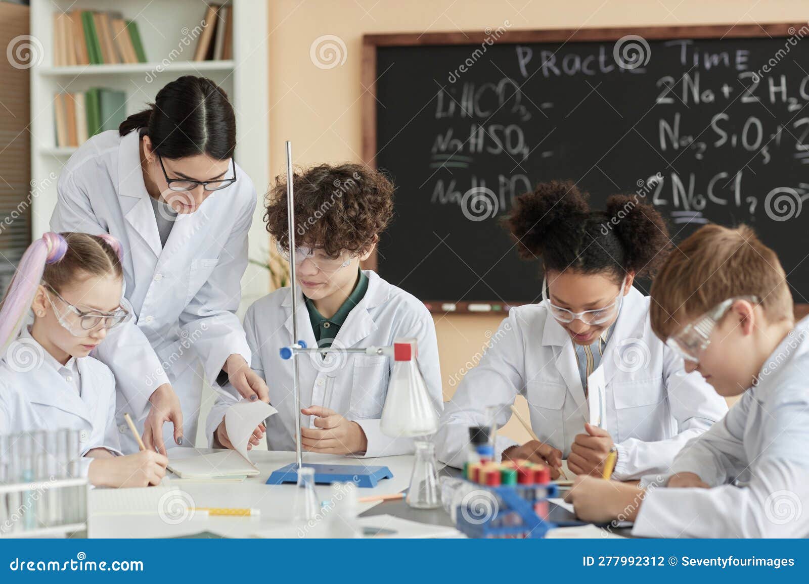 Group of Children Wearing Lab Coats in Science Class at School Teacher ...