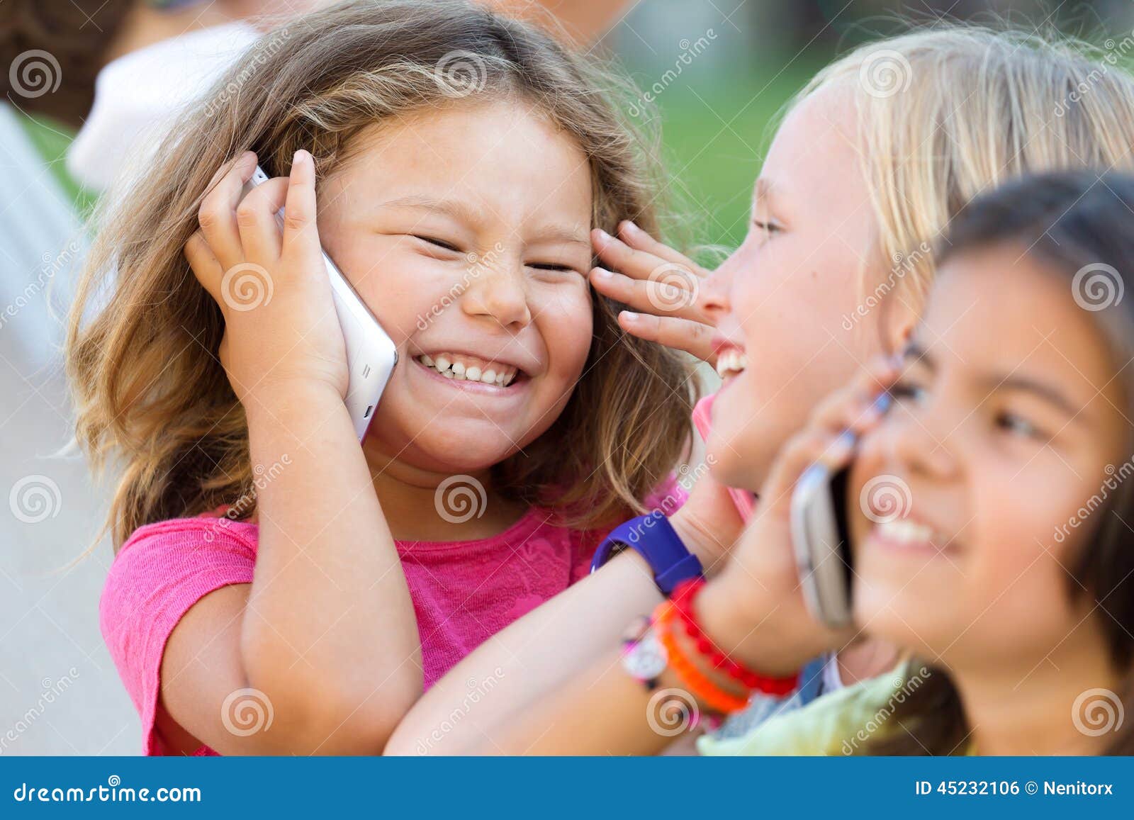 Group of Childrens Using Mobile Phones in the Park. Stock Photo - Image ...