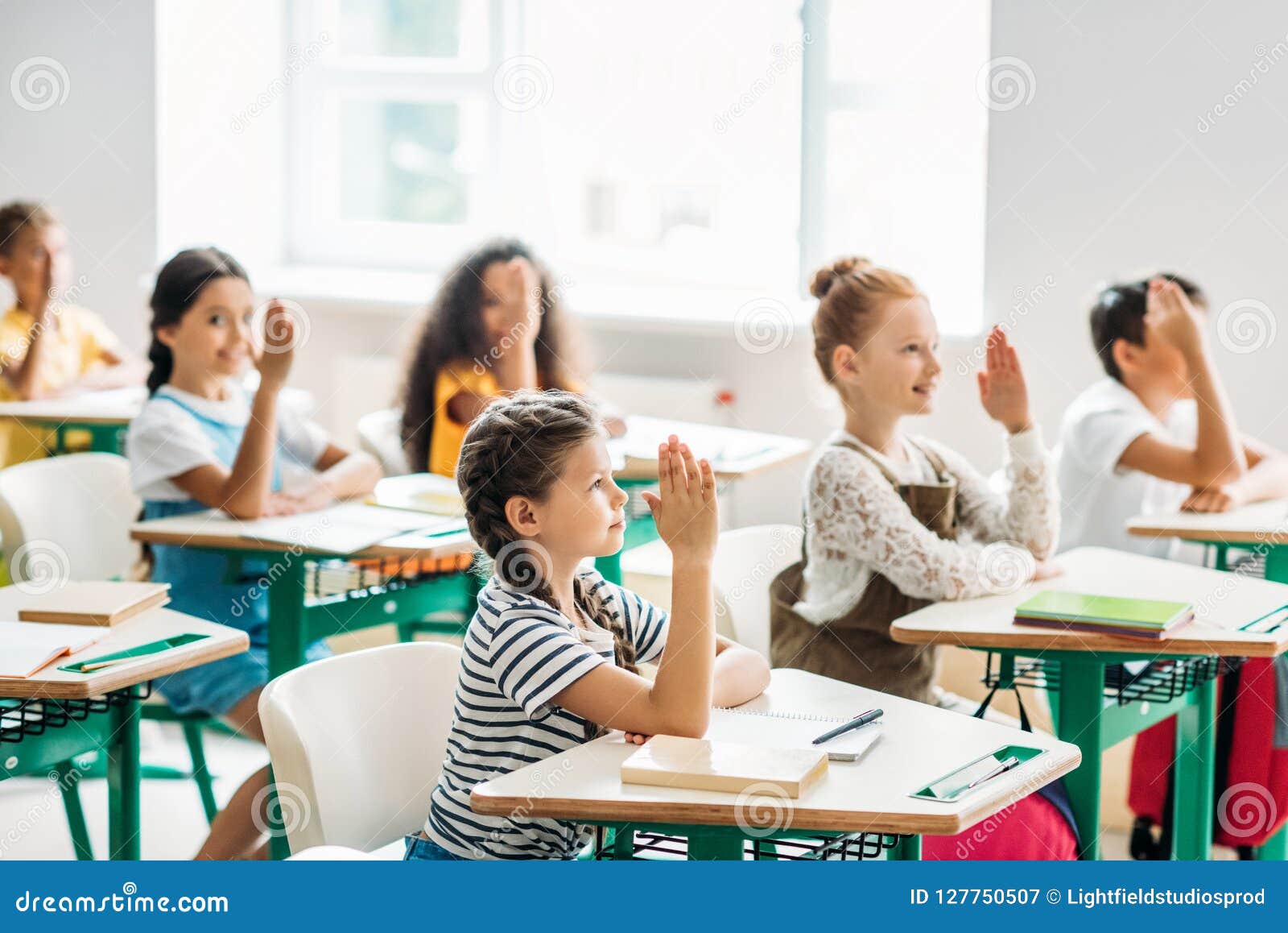 Group of Classmates Raising Hands To Answer Question Stock Image ...