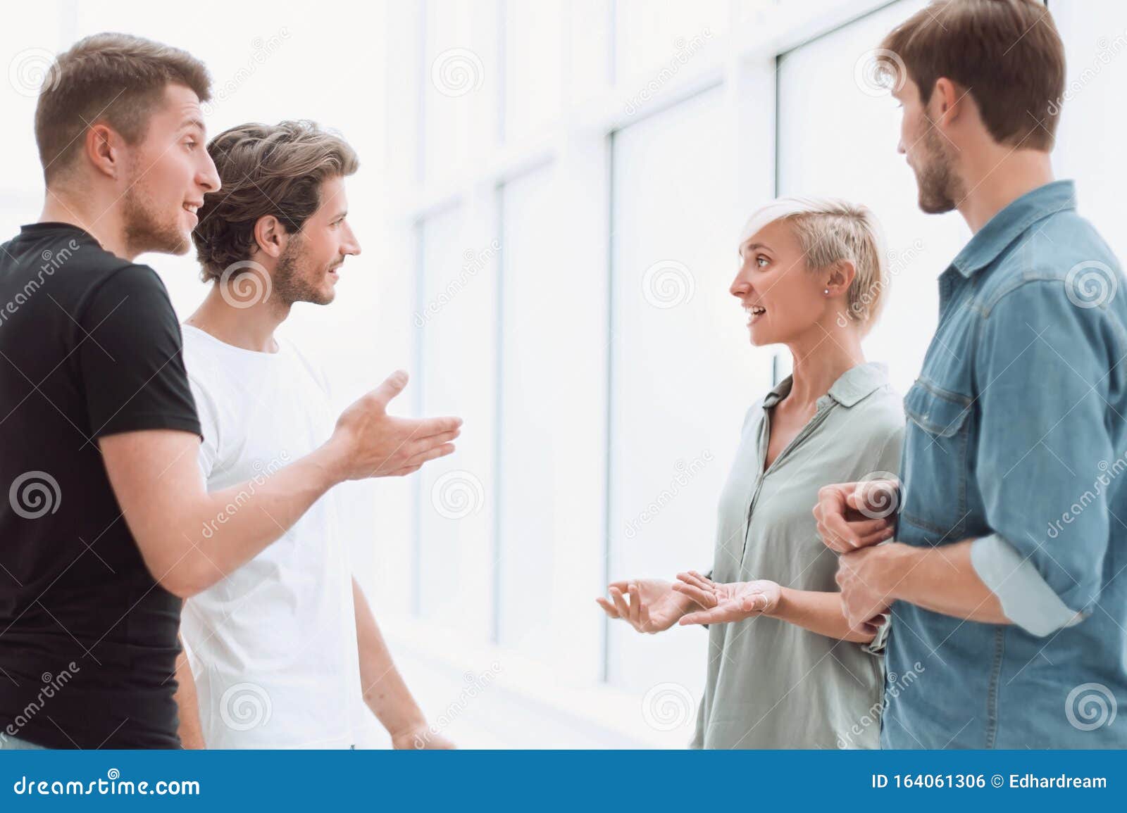 Group of Co-workers are Discussing Something in the Office Corridor ...