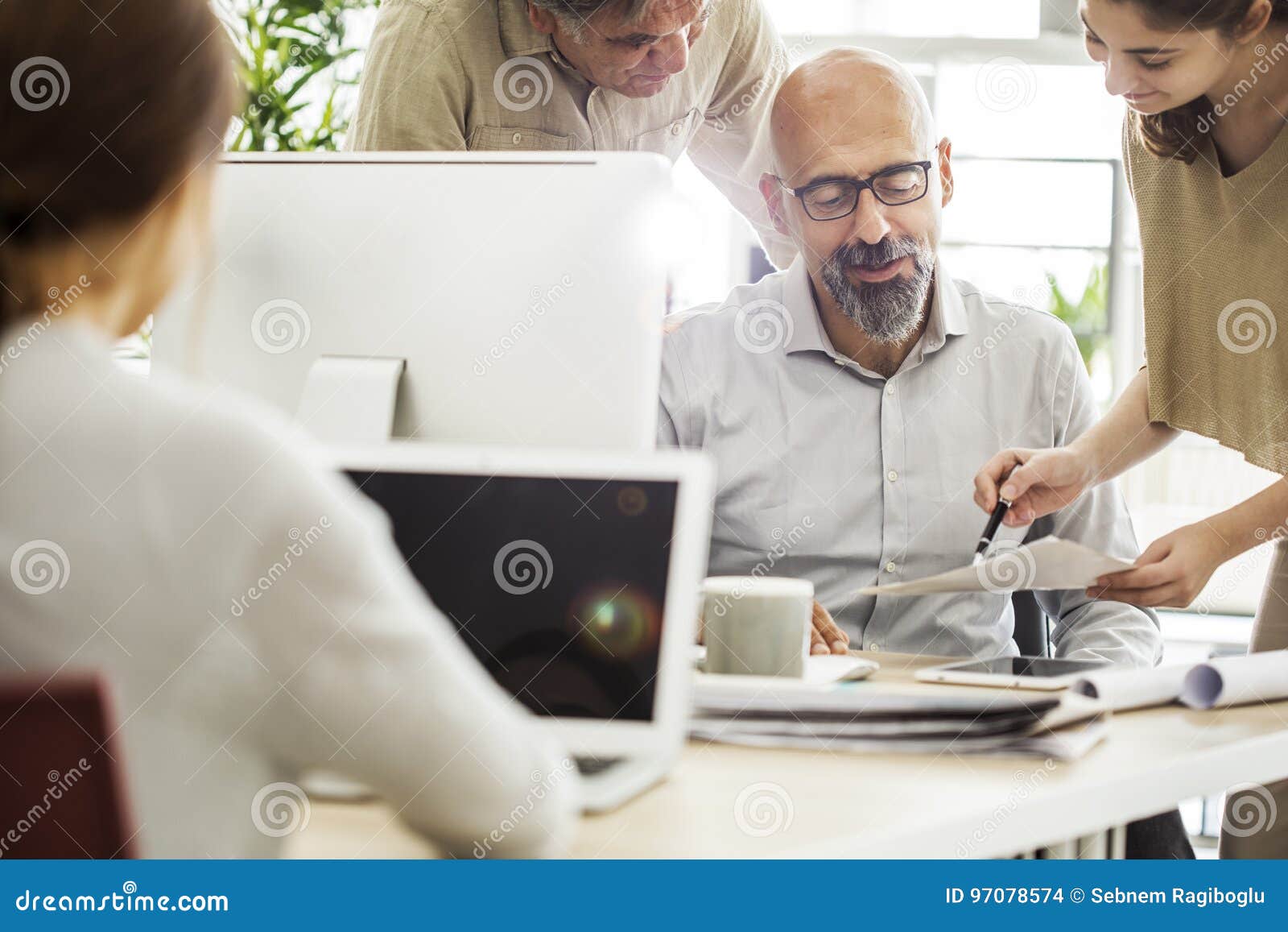 Group of Colleagues Talking Around a Table Stock Photo - Image of ...