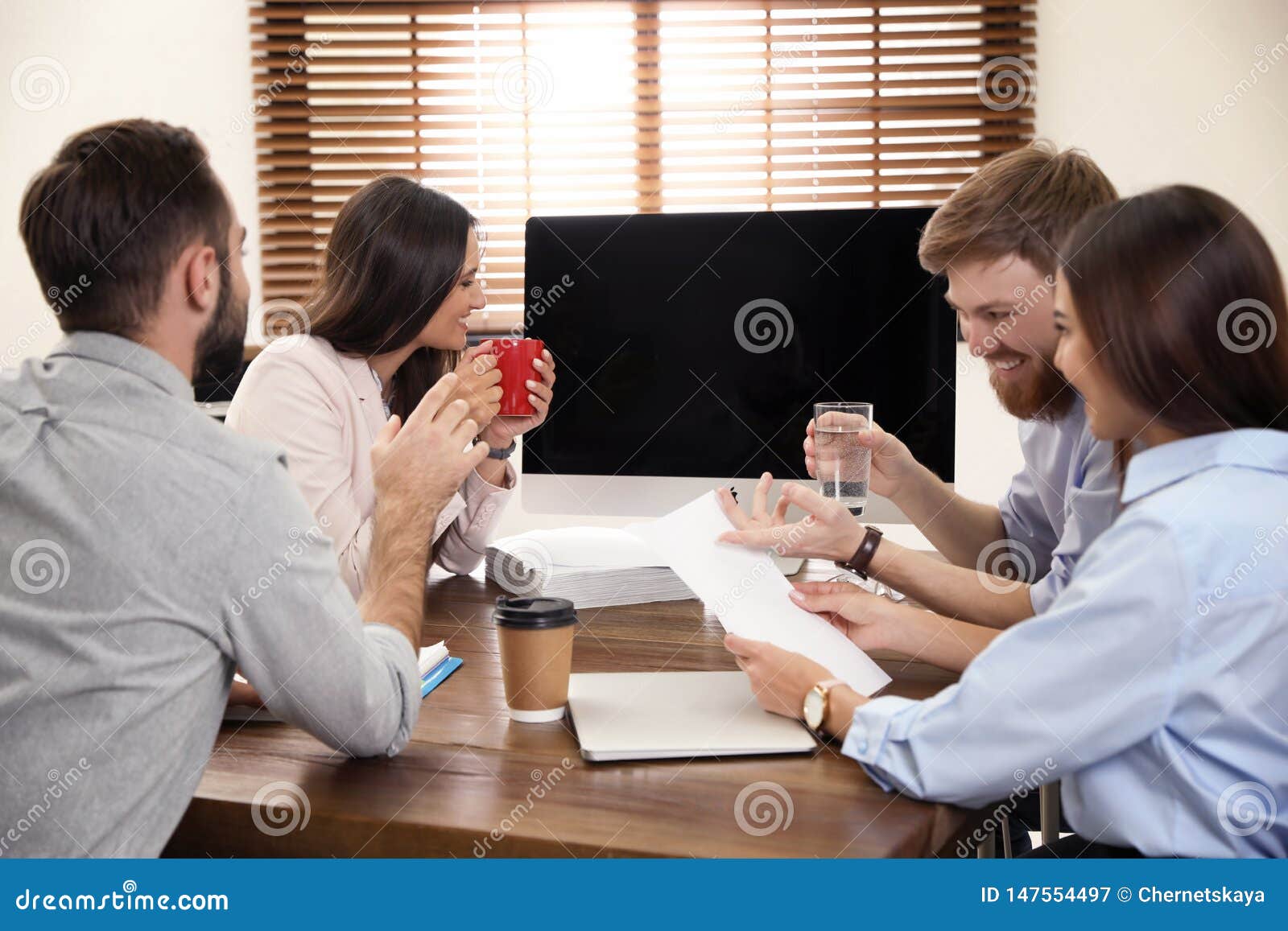 Group of Colleagues Using Video Chat on Computer in Office Stock Image ...