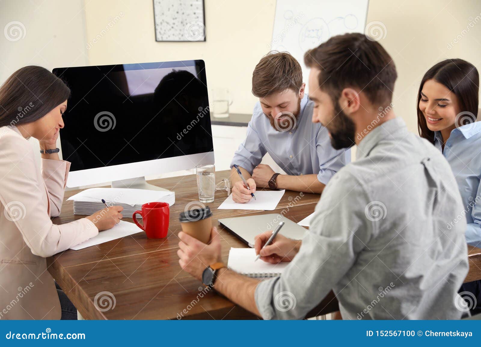 Group of Colleagues Using Video Chat on Computer in Office Stock Photo ...