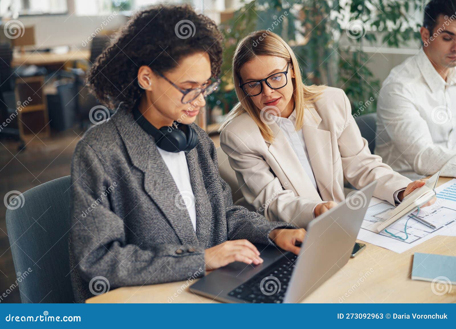 Group of Colleagues Working Together with Documents while Sitting on ...