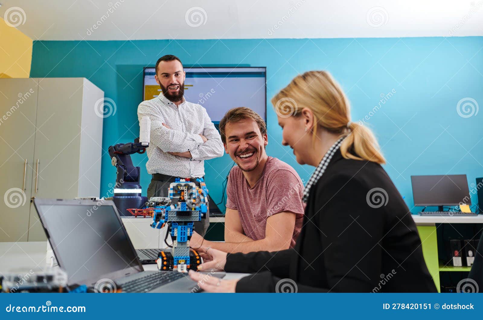A Group of Colleagues Working Together in a Robotics Laboratory ...