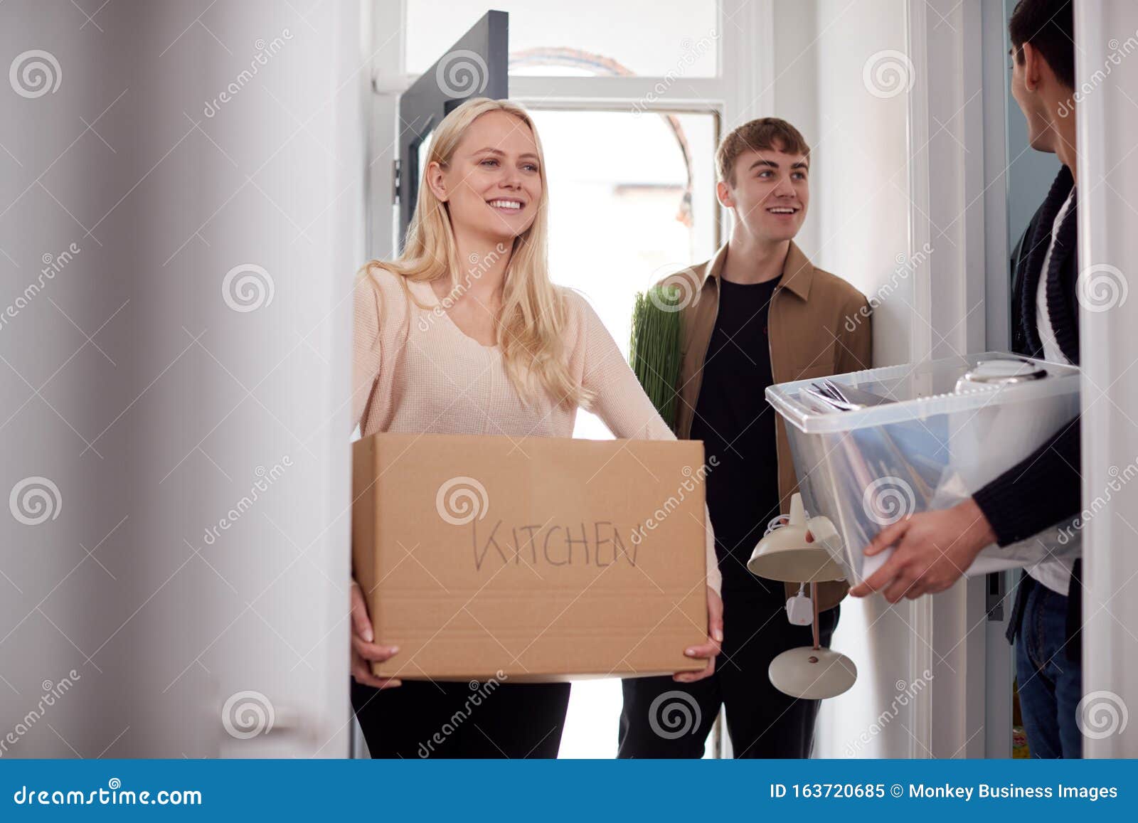 Group of College Student Carrying Boxes Moving into Accommodation ...