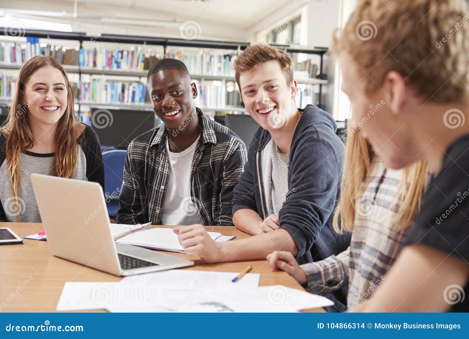 Group of College Students Collaborating on Project in Library Stock ...