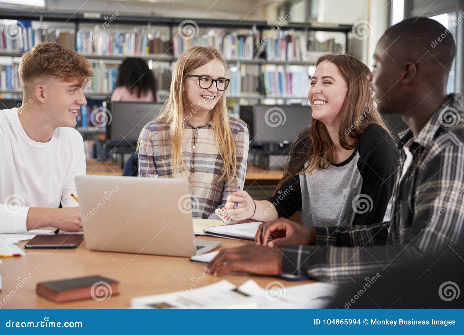 Group of College Students Collaborating on Project in Library Stock ...