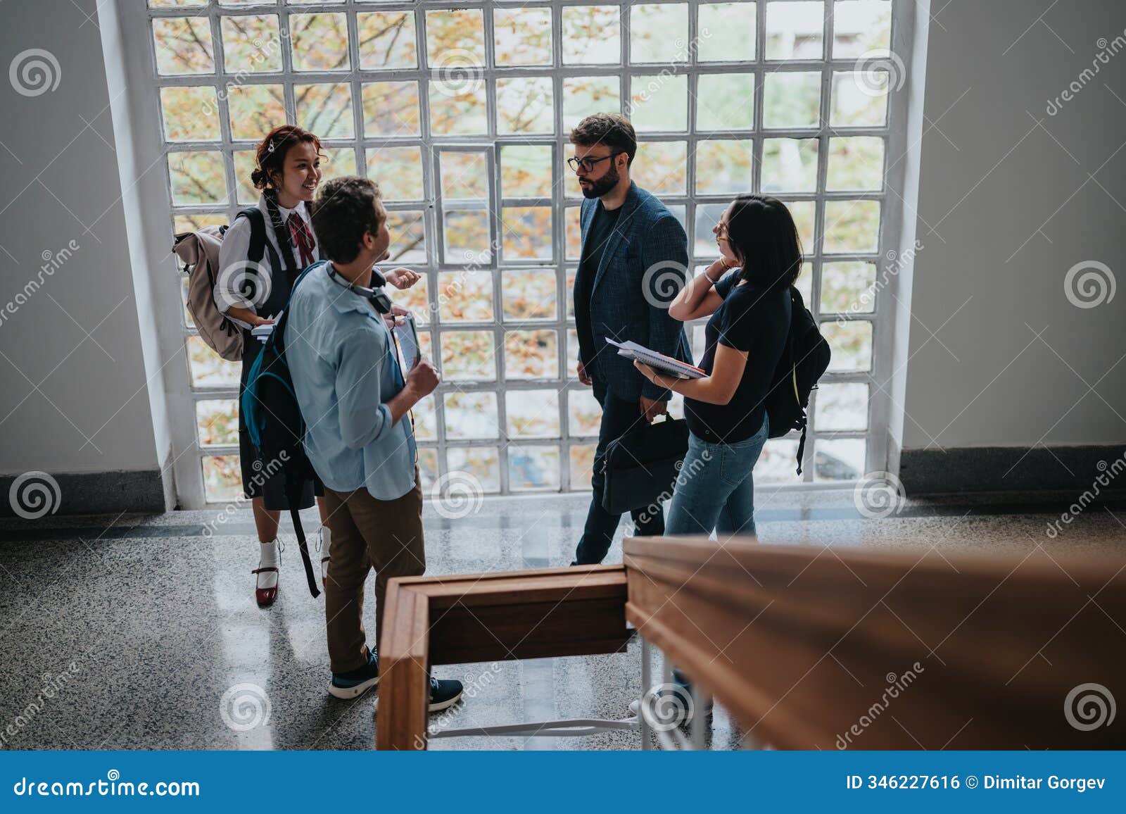 Students Engage in a Thoughtful Discussion with Their Professor Stock ...