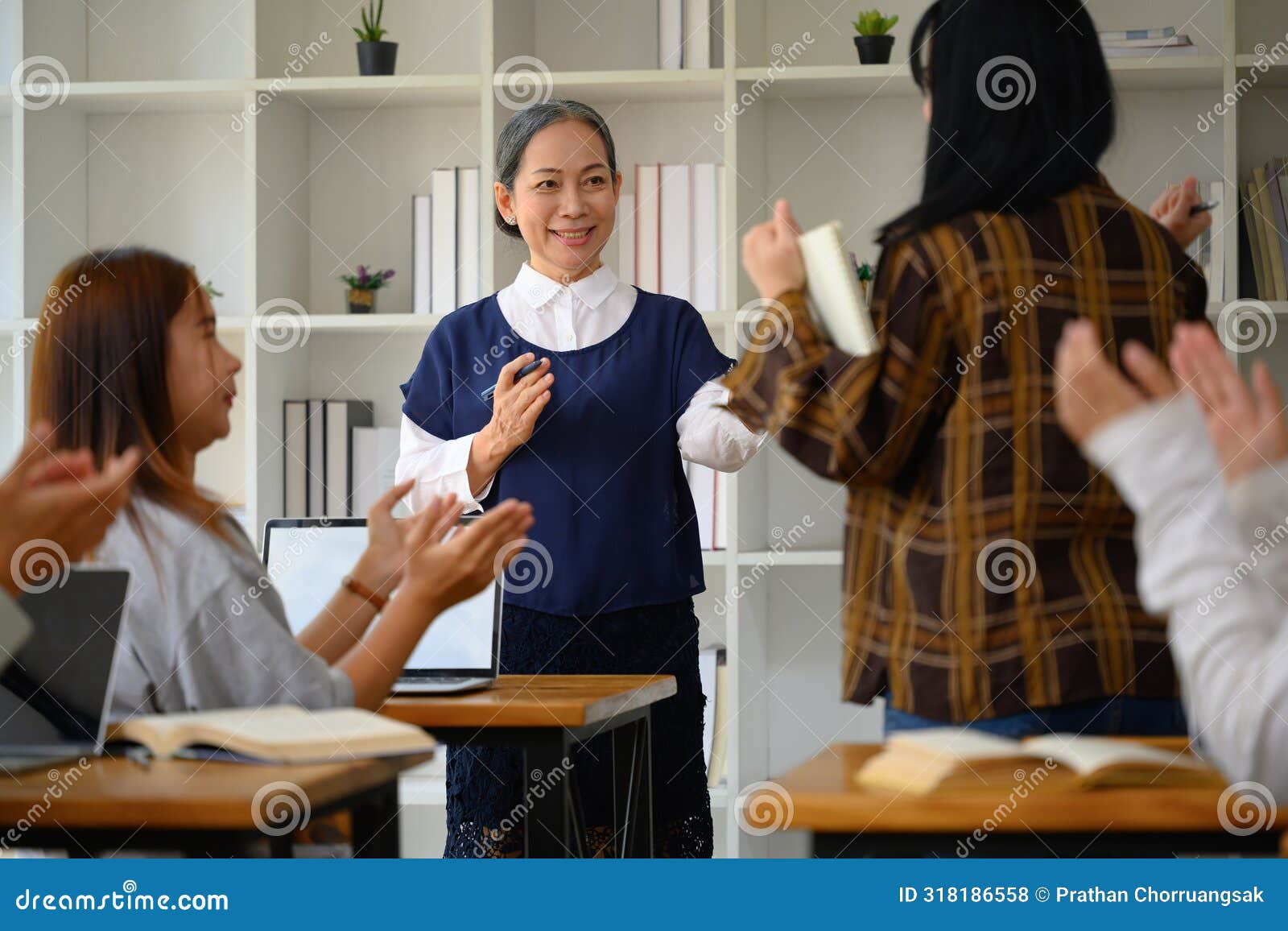 Group of College Students and Professor Applauding To Their Classmate ...