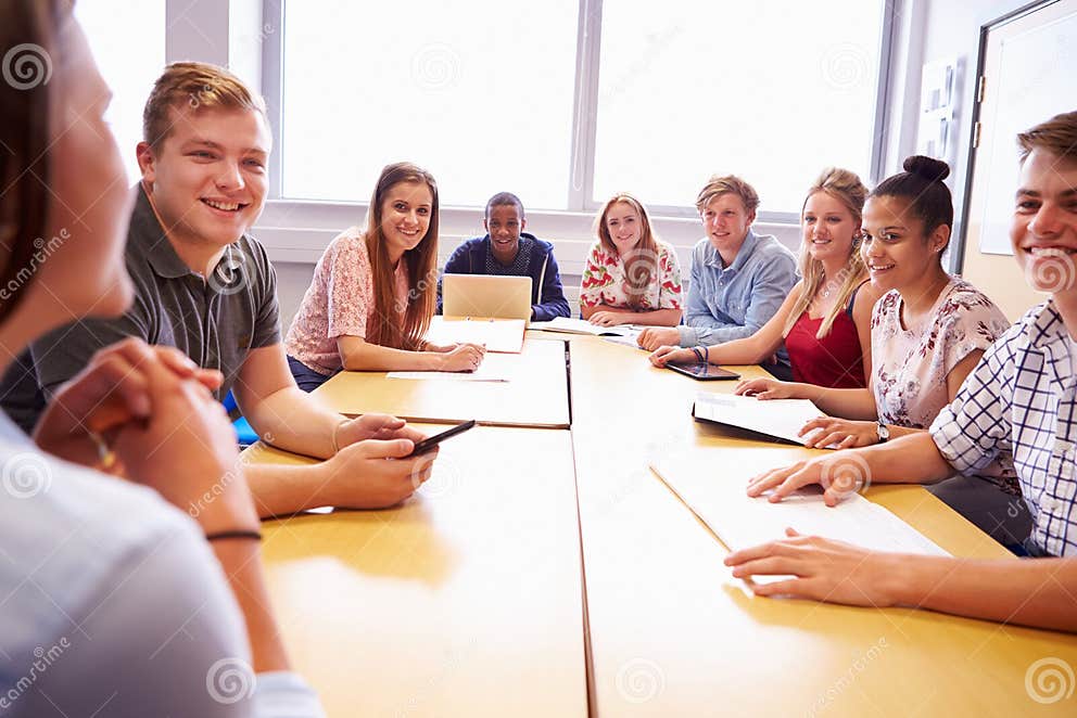 Group of College Students Sitting at Table Having Discussion Stock ...