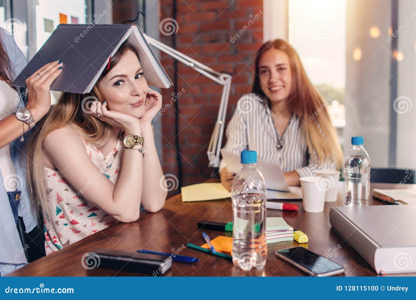 Group of College Students Sitting at Work Table in Classroom Stock ...