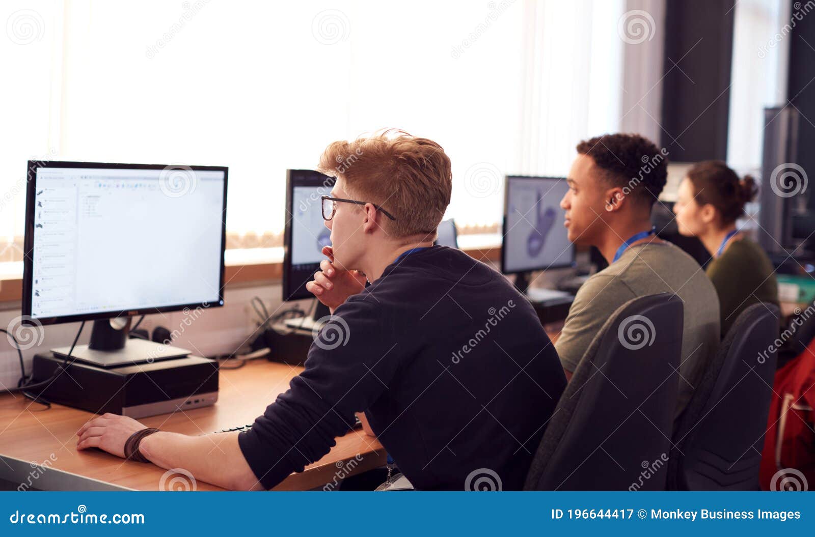 Group of College Students Studying Computer Design Sitting at Line of ...