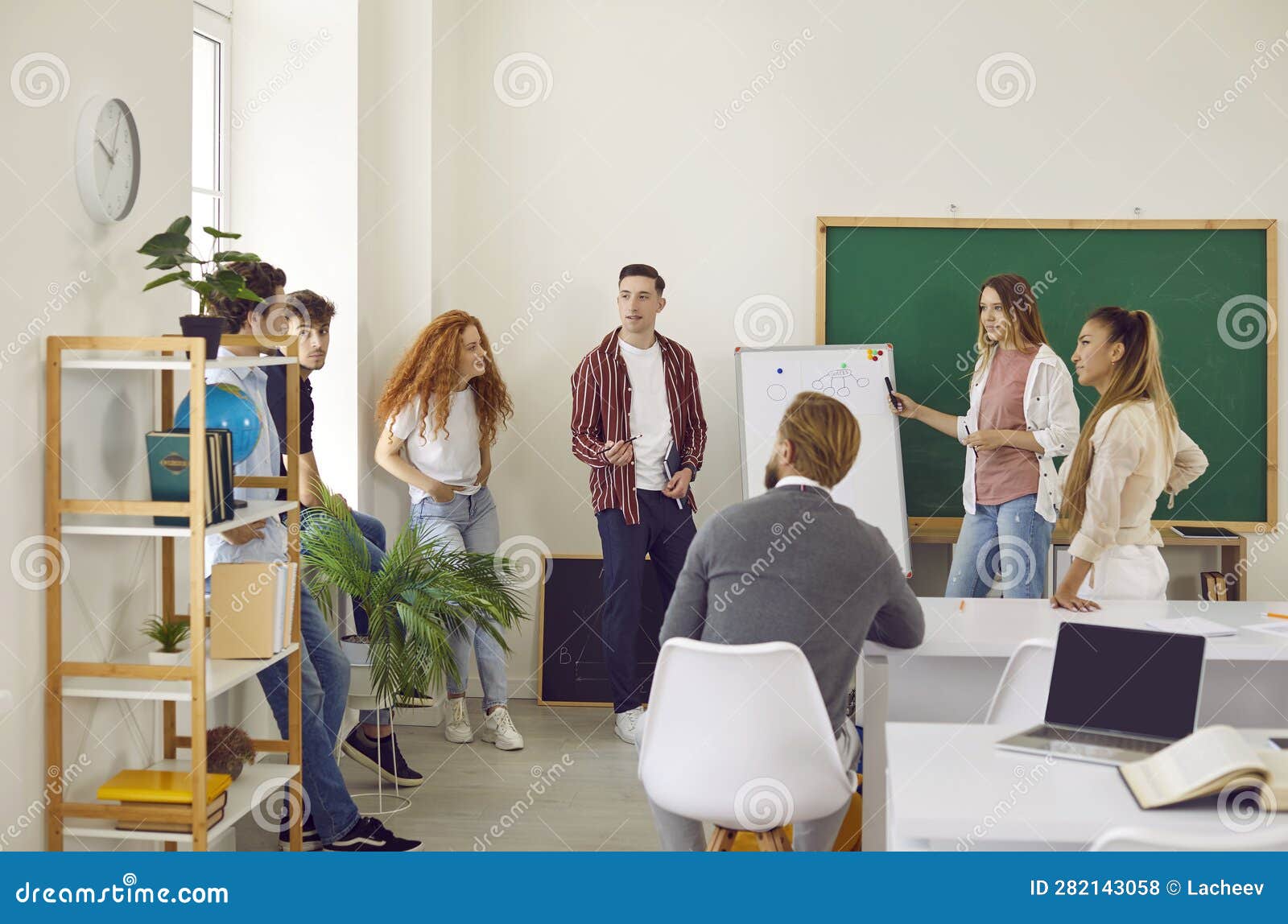 Group of College Students and Teacher Discuss Project Using Whiteboard ...