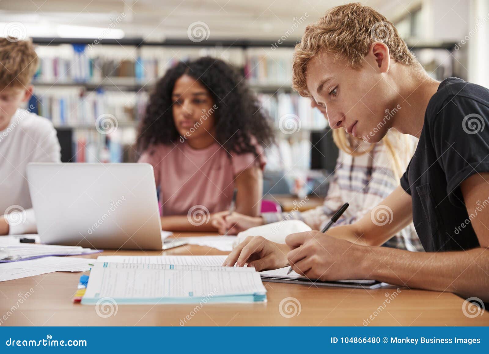 Group of College Students Working Around Table in Library Stock Photo ...