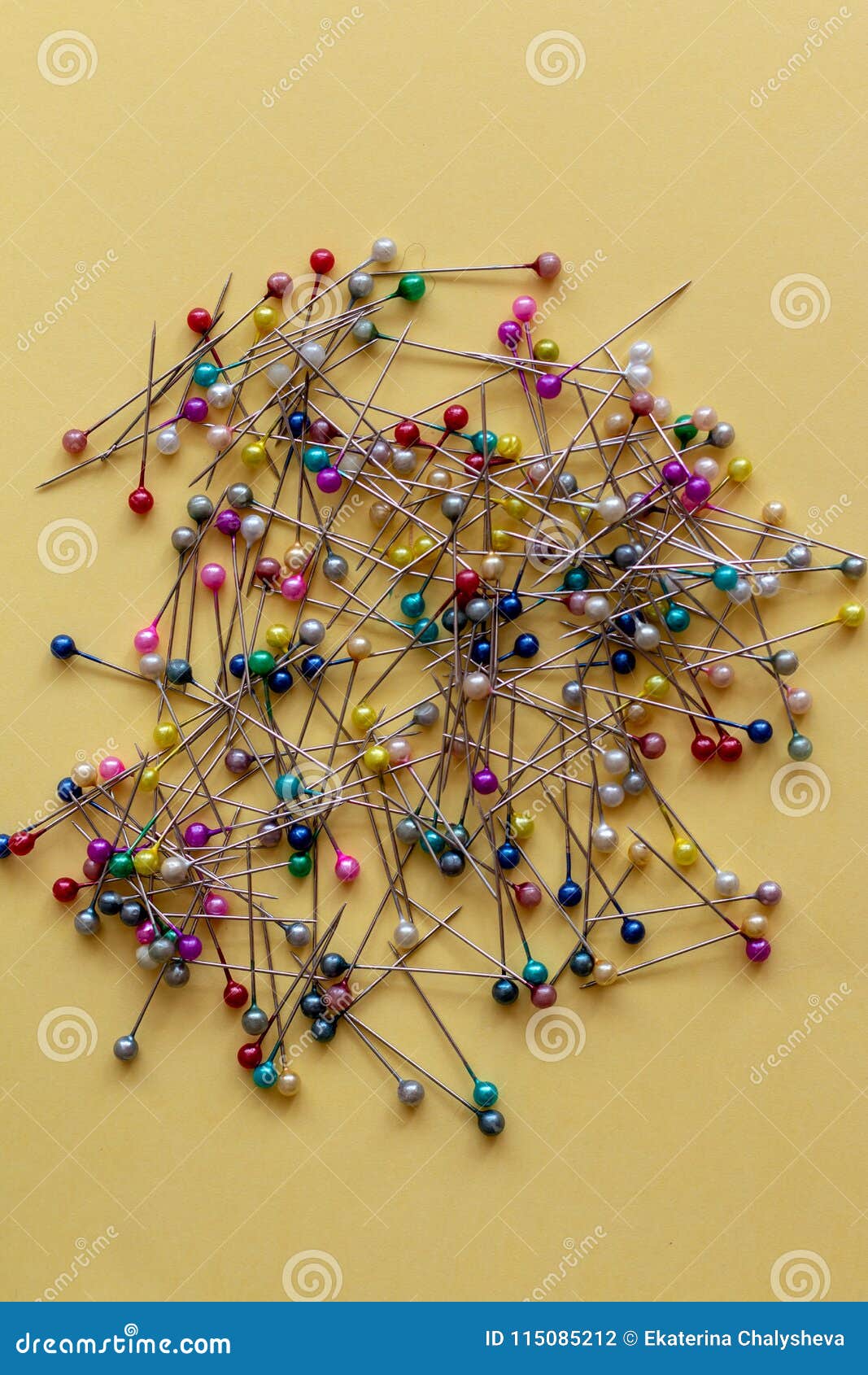 A Group of Colored Sewing Pins on a Yellow Background Stock Photo ...