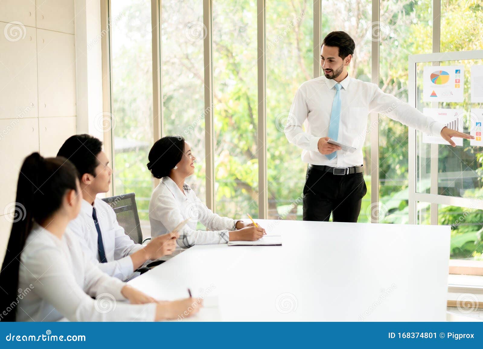 Group of Confident Business People Analyzing and Discussion Data in the ...