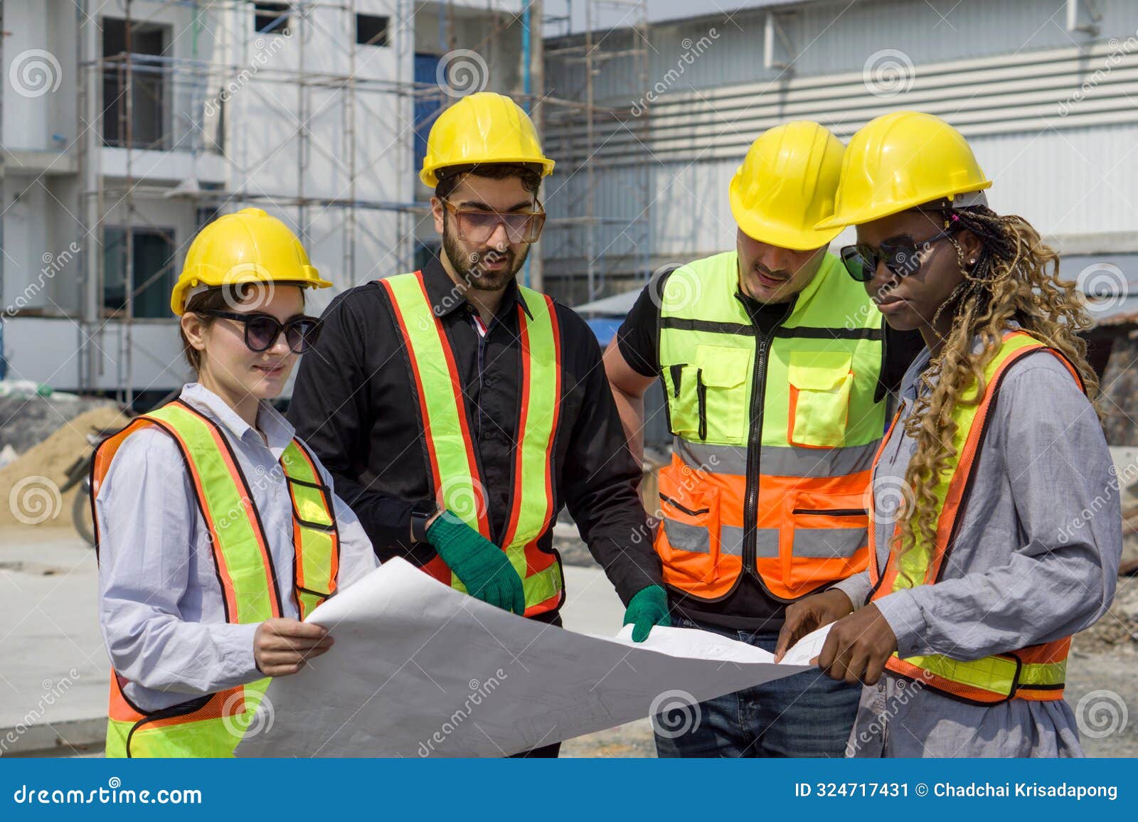 Group of Construction Worker Gathered at a Construction Site Reviewing ...