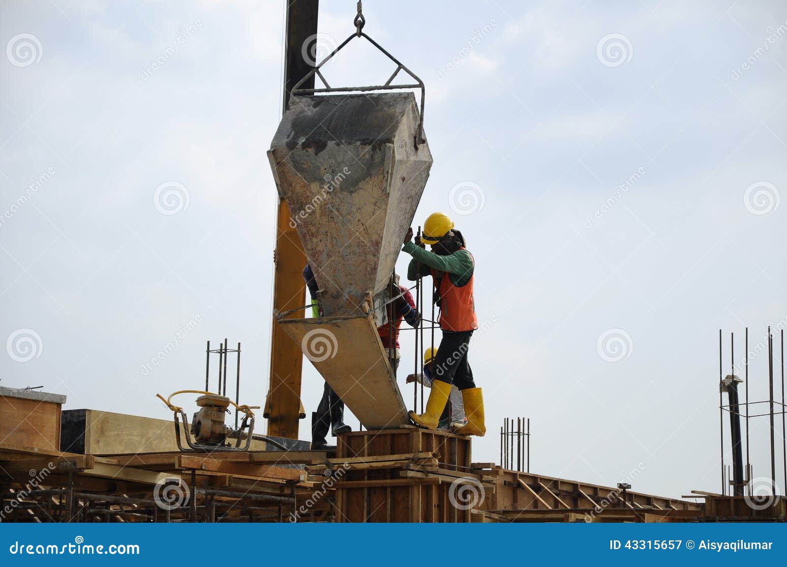 A Group of Construction Workers Pouring Concrete into Formwork Stock ...
