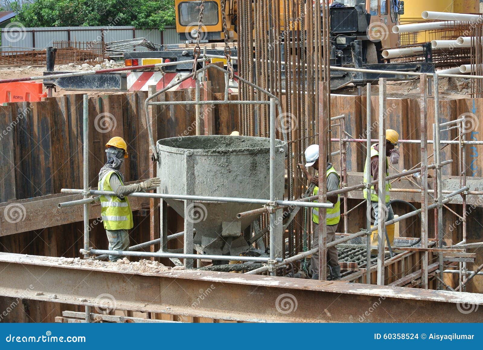 A Group of Construction Workers Pouring Concrete into Pile Cap Formwork ...