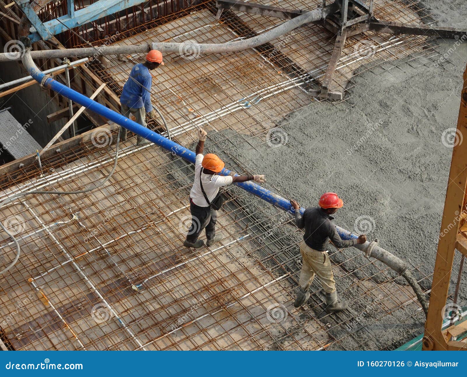 Group of Construction Workers Pouring Wet Concrete Using the Concrete ...