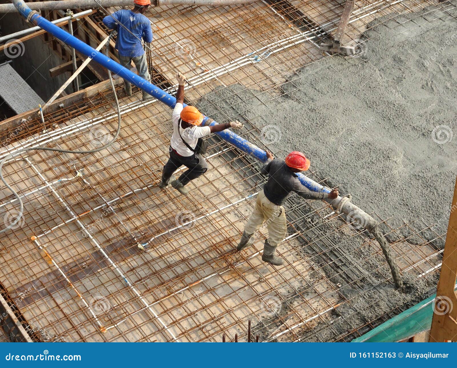 Group of Construction Workers Pouring Wet Concrete Using the Concrete ...