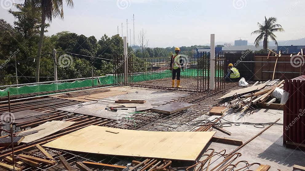 Group of Construction Workers Working at the Construction Site. the Building Structure on ...