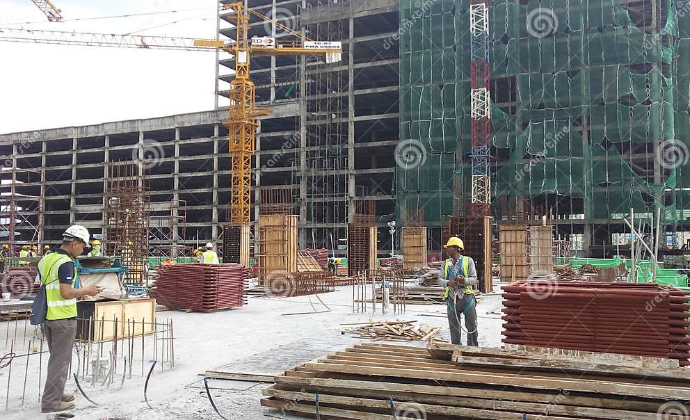 Group of Construction Workers Working at the Construction Site. the Building Structure on ...