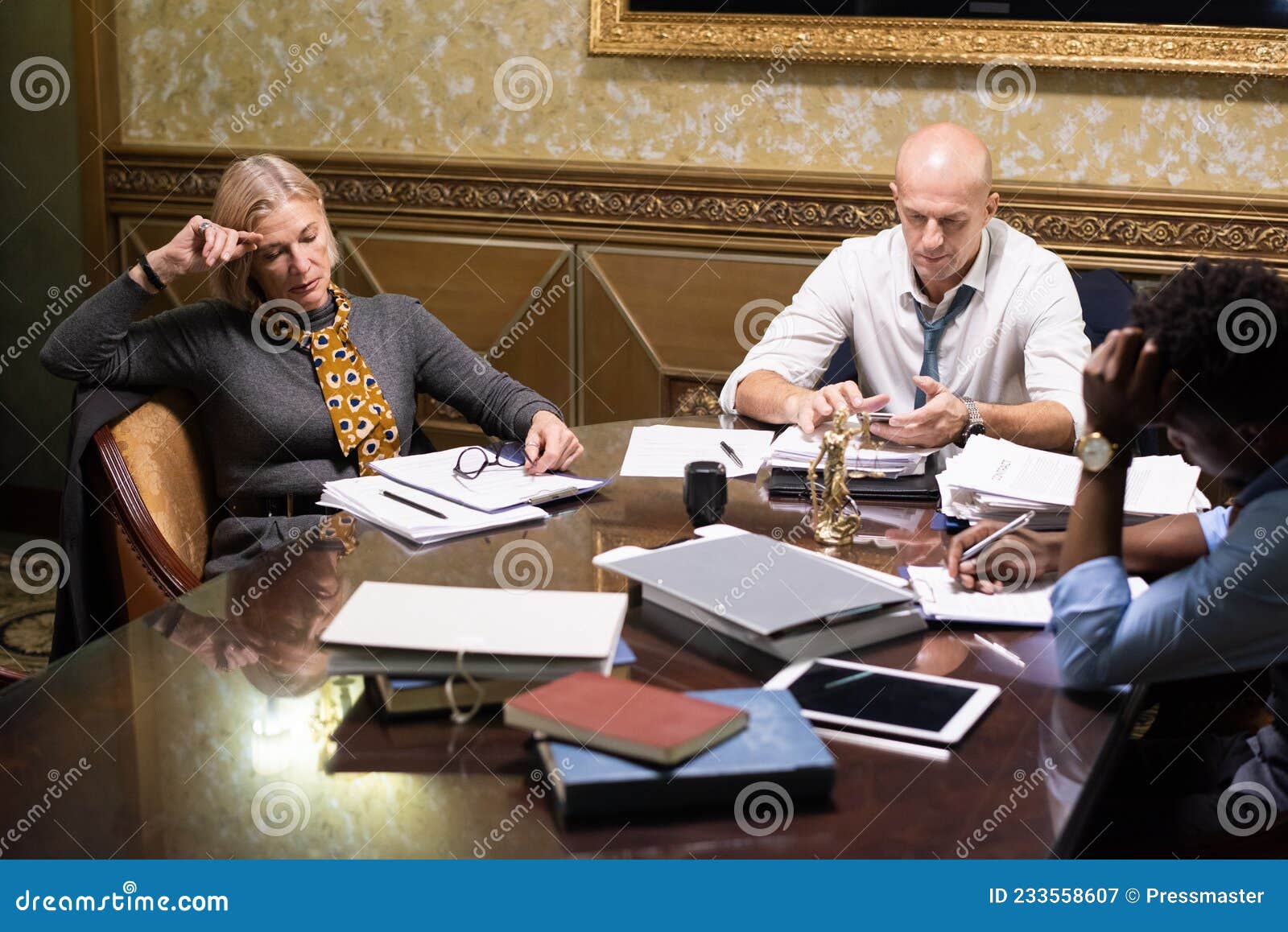 Group of Contemporary Jurists Sitting by Table and Working Individually ...