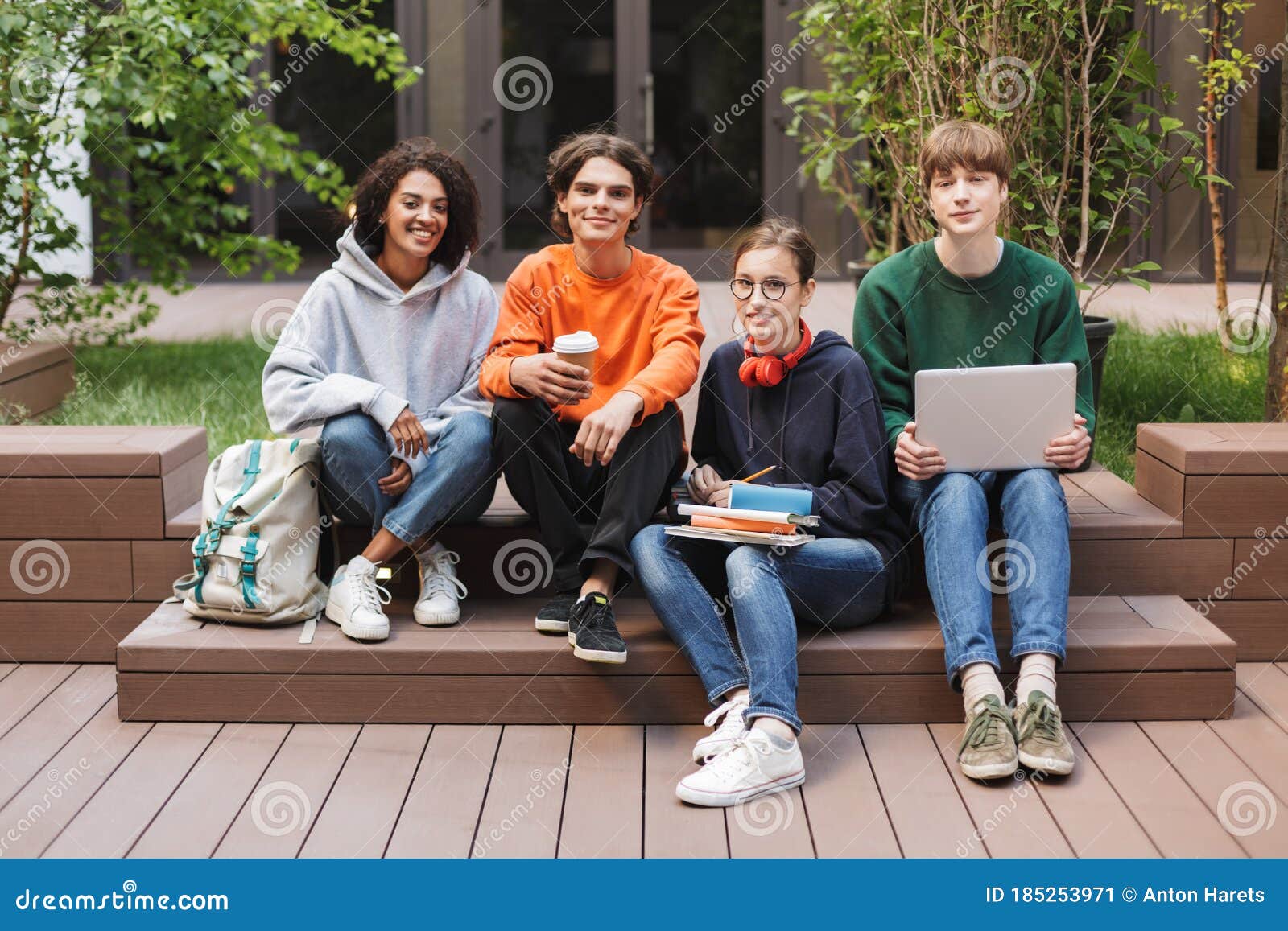 Group of Cool Joyful Students Sitting and Happily Looking in Camera ...