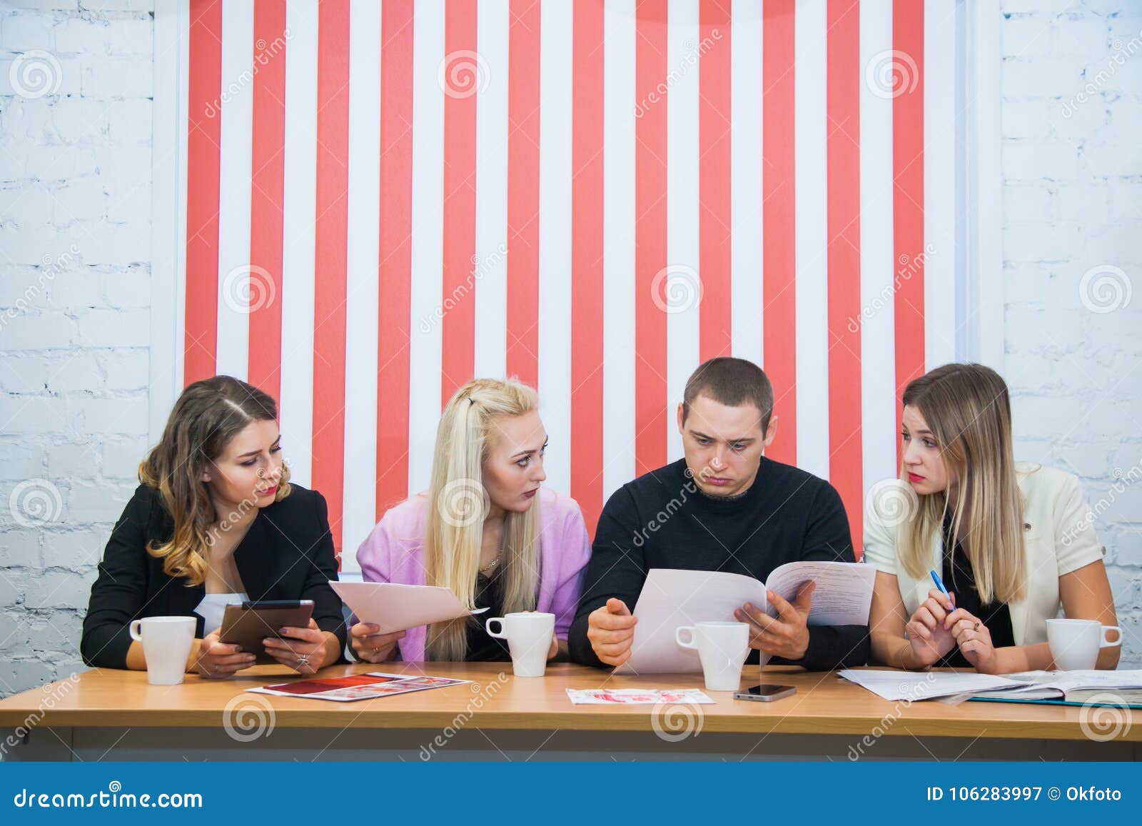 Group of Creative Young People Sit and Work Together Sign Document ...