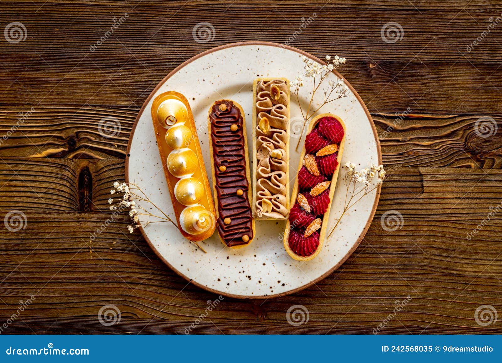 Group of Decorated Eclairs with Pistachio Raspberries and Chocolate ...