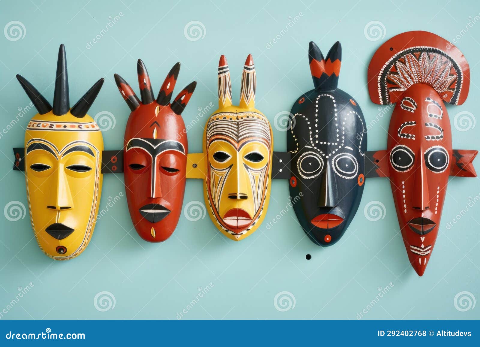 A Group of Decorative African Masks Set Against a Bright Wall Stock ...