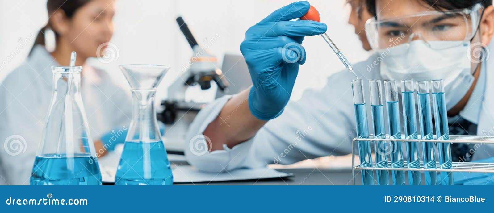 Group of Dedicated Scientist Drop Precise Amount of Liquid. Neoteric ...