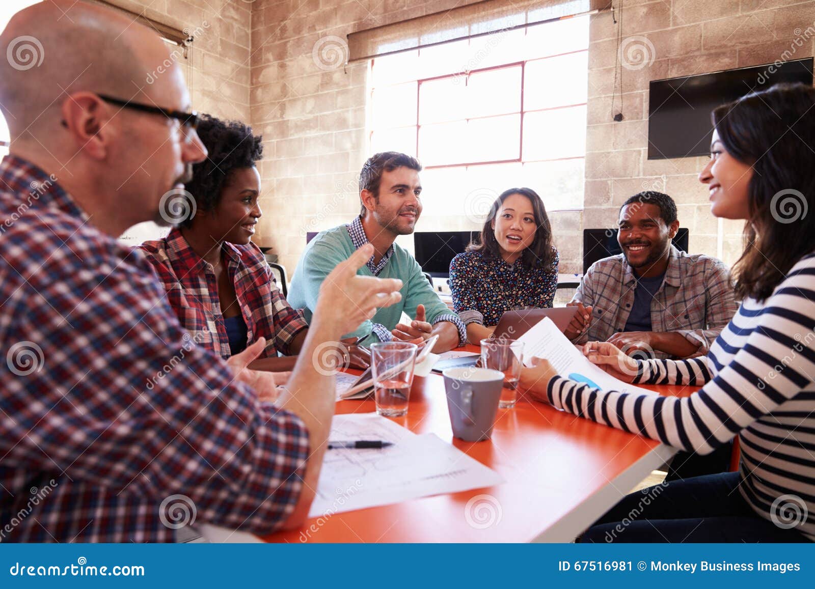 Group of Designers Having Meeting Around Table in Office Stock Image ...