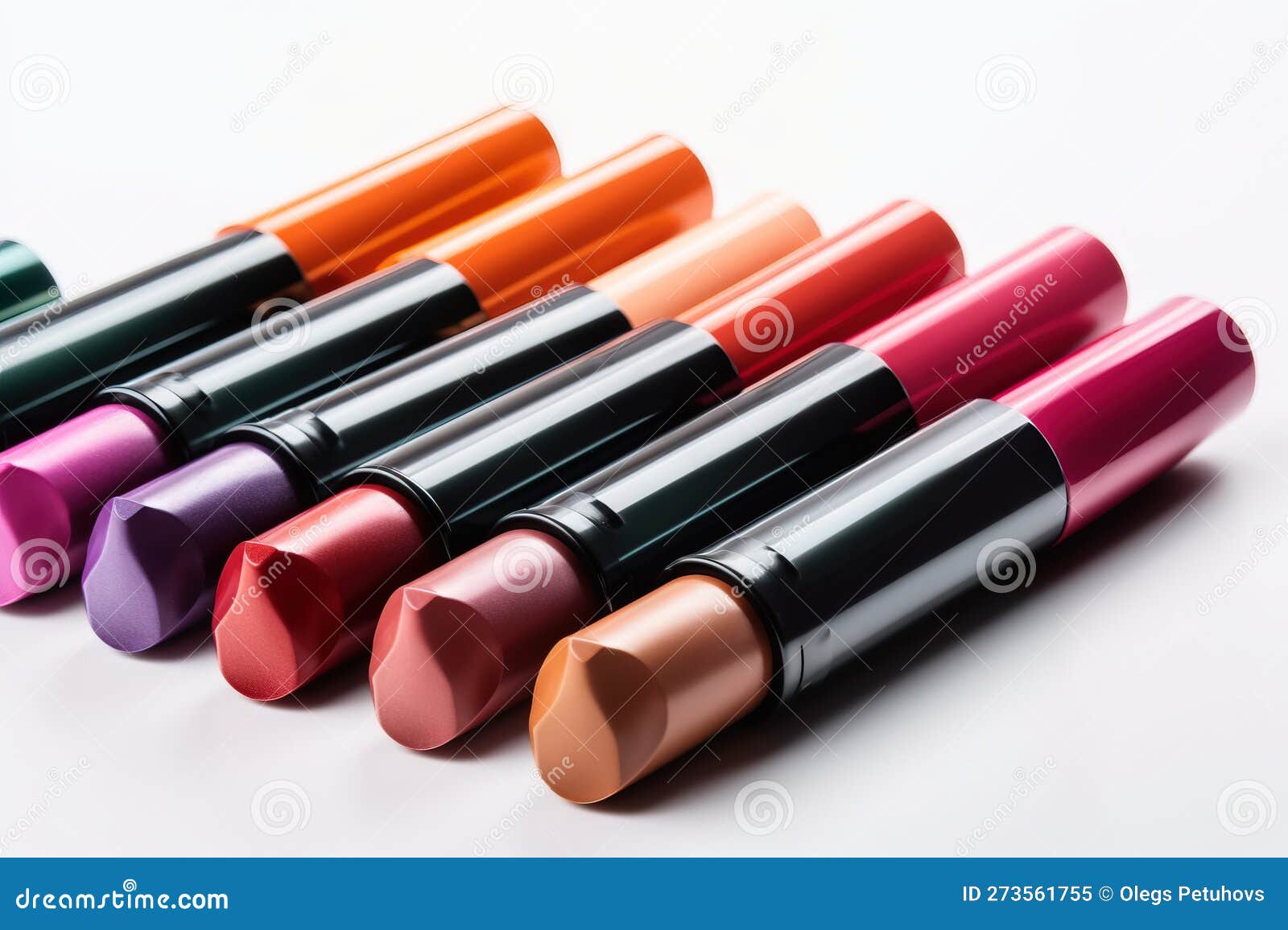 A Group of Different Colored Lipsticks on a White Surface with One of ...