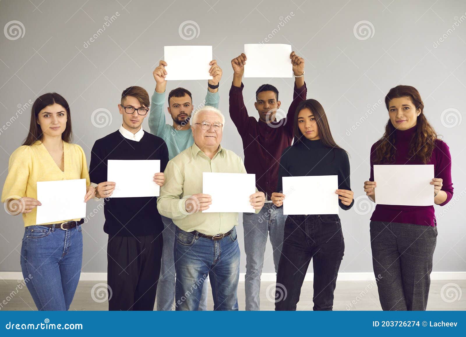 Group of Different People Standing Together, Holding White Sheets of ...